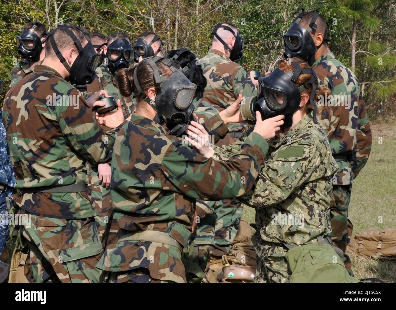 U.S. Sailors don their gas masks during a chemical, biological and ...