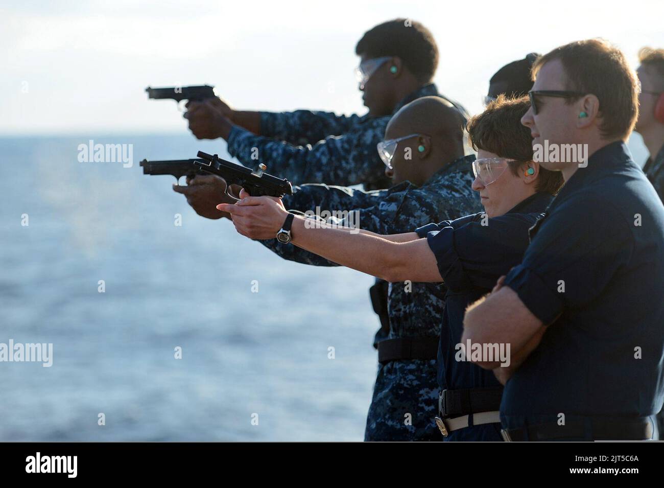 U.S. Sailors fire M9 pistols during a small arms shoot aboard the ...