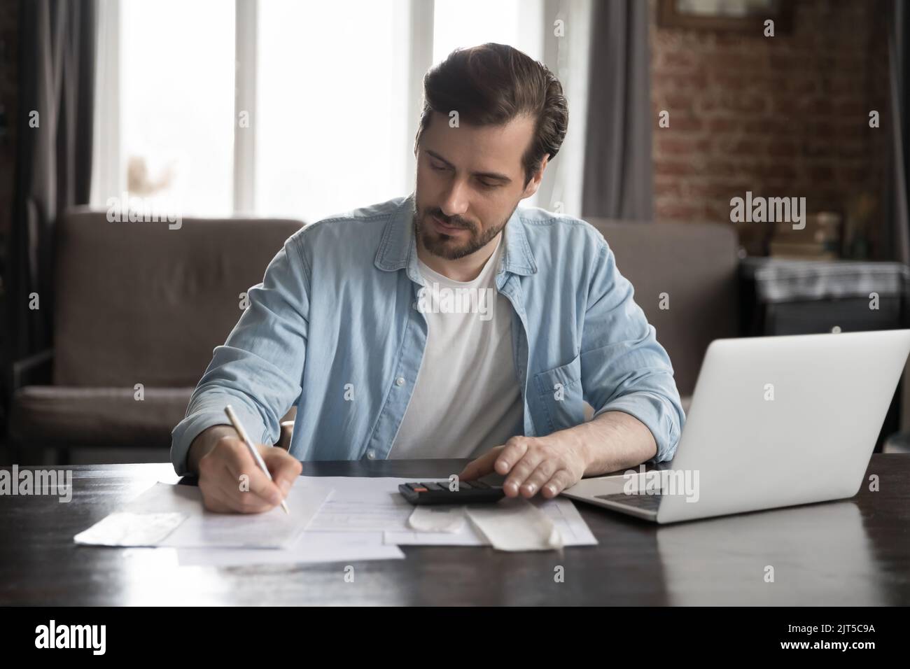 Serious handsome computer user man doing accounting job Stock Photo - Alamy