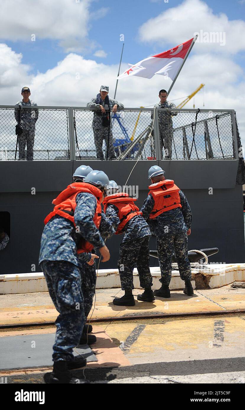 U.S. Sailors help moor the Singapore frigate RSS Intrepid (F 69) as it ...