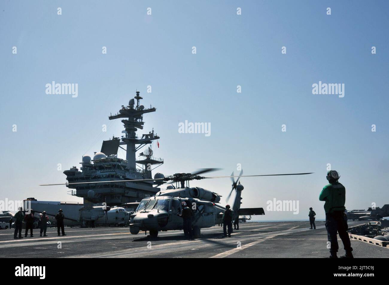 U.S. Sailors make final inspections before refueling an MH-60S Seahawk ...
