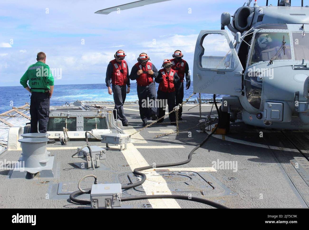 U.S. Sailors inspect the flight deck of the guided missile destroyer ...