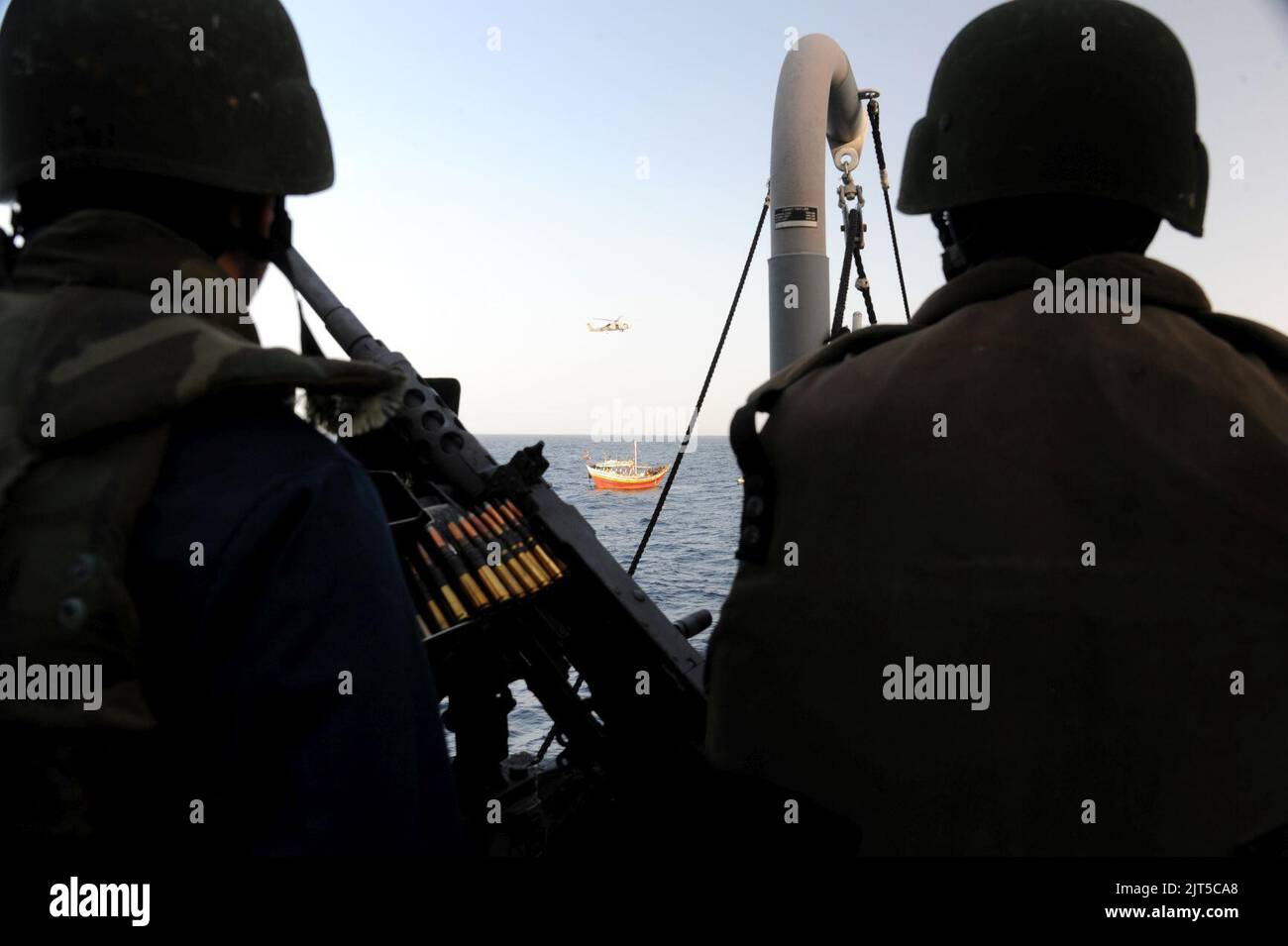 U.S. Sailors man an M2 .50 caliber machine gun aboard the guided ...