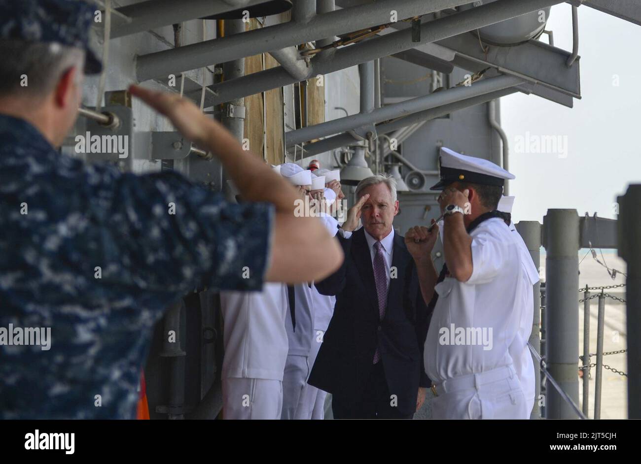 U.S. Sailors salute Secretary of the Navy Ray Mabus as he arrives ...