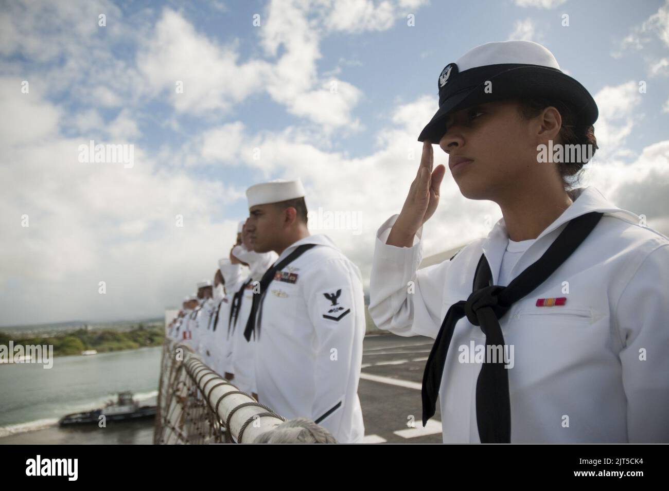 U.S. Sailors salute on the hospital ship USNS Mercy (T-AH 19) as the ...
