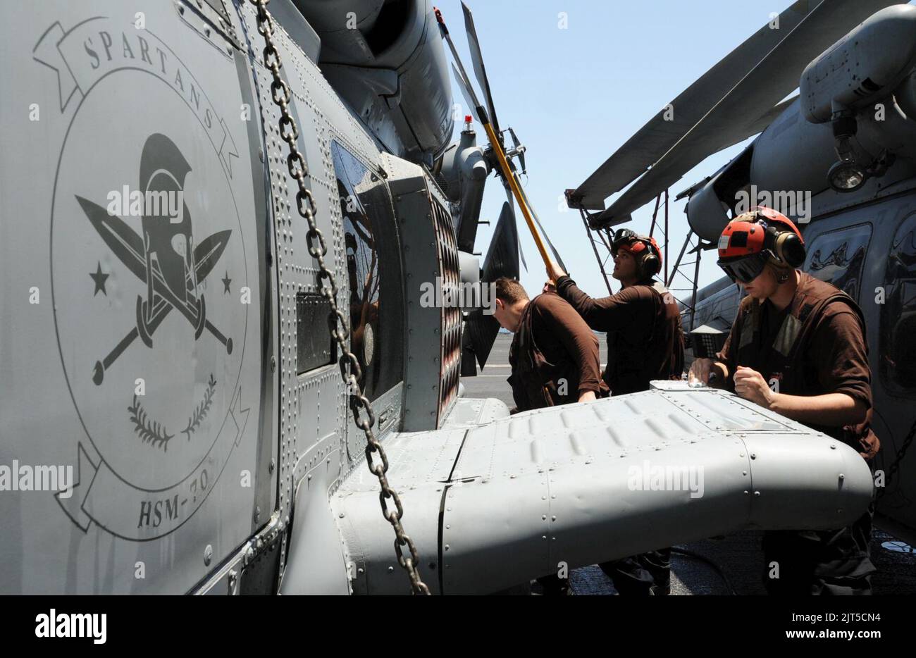 U.S. Sailors wash an MH-60R Seahawk helicopter assigned to Helicopter ...