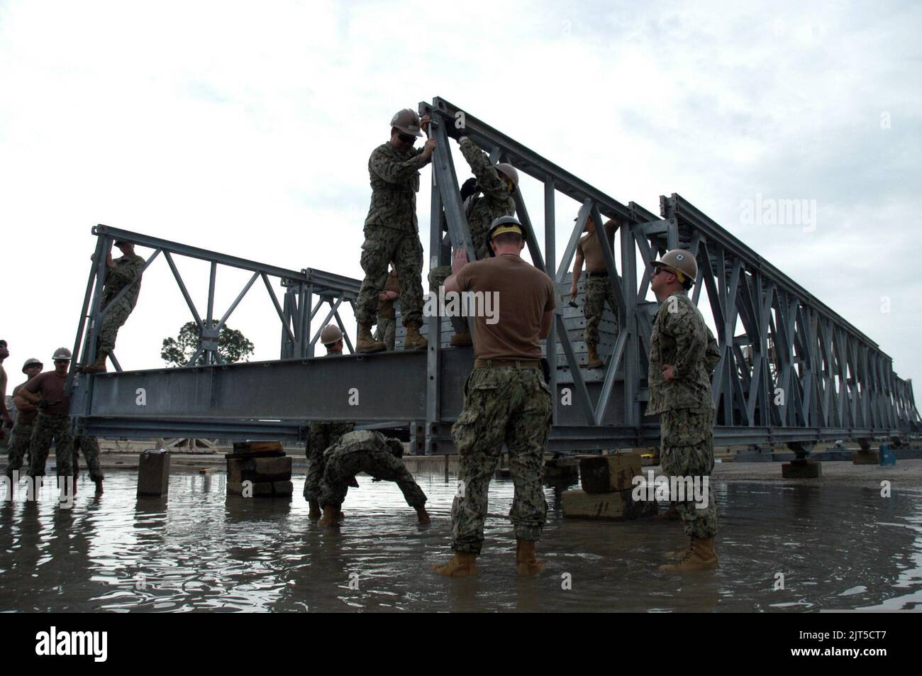 U.S. Sailors with Naval Mobile Construction Battalion (NMCB) 25 finish ...
