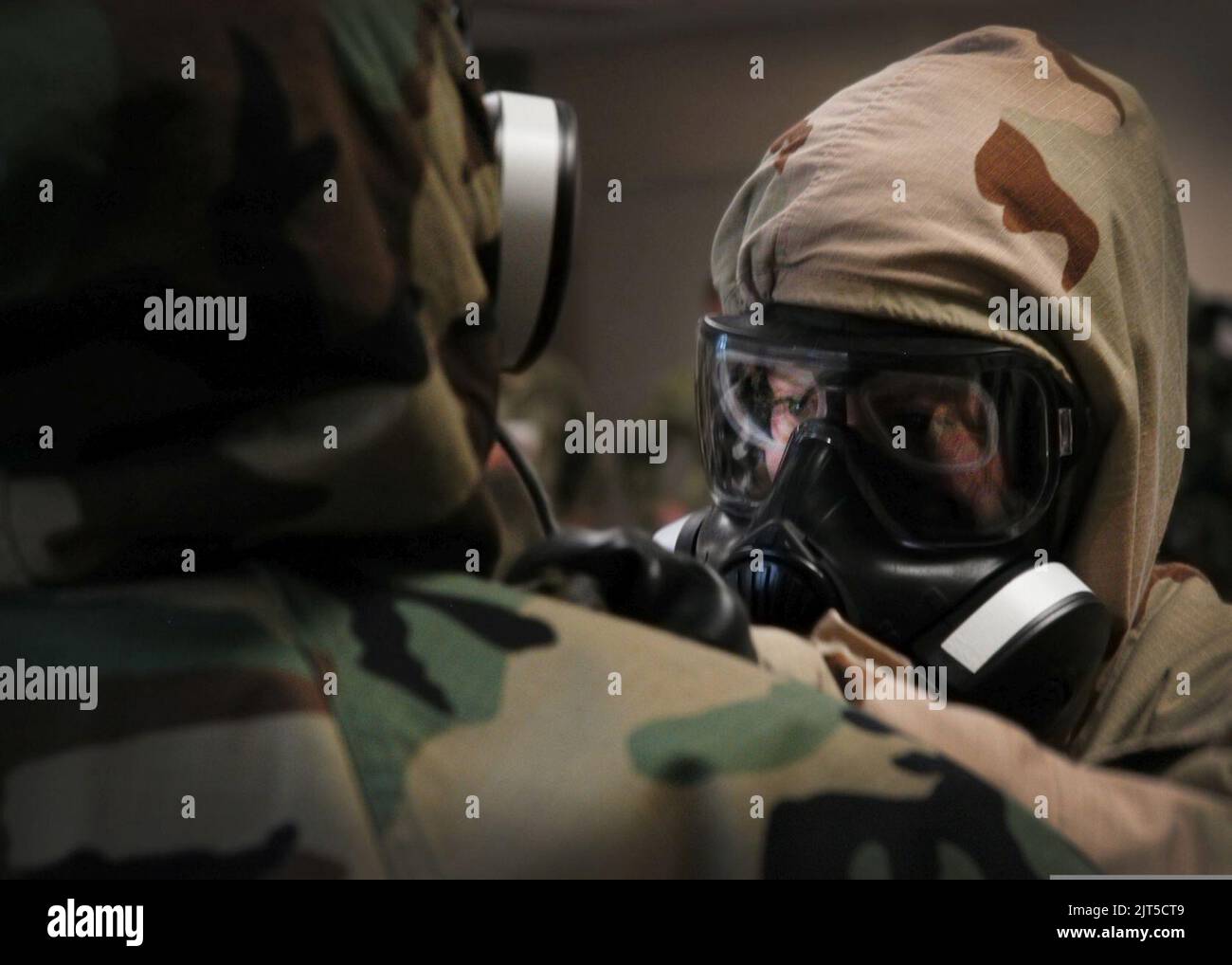 U.S. Sailors with Naval Mobile Construction (NMCB) 25 check each other ...