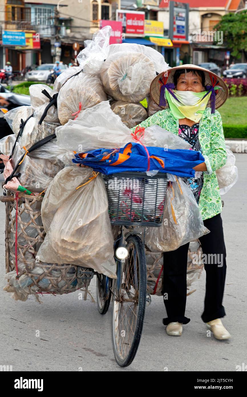 Vietnamese lady using bicycle to recycle waste and garbage, Hai Phong ...