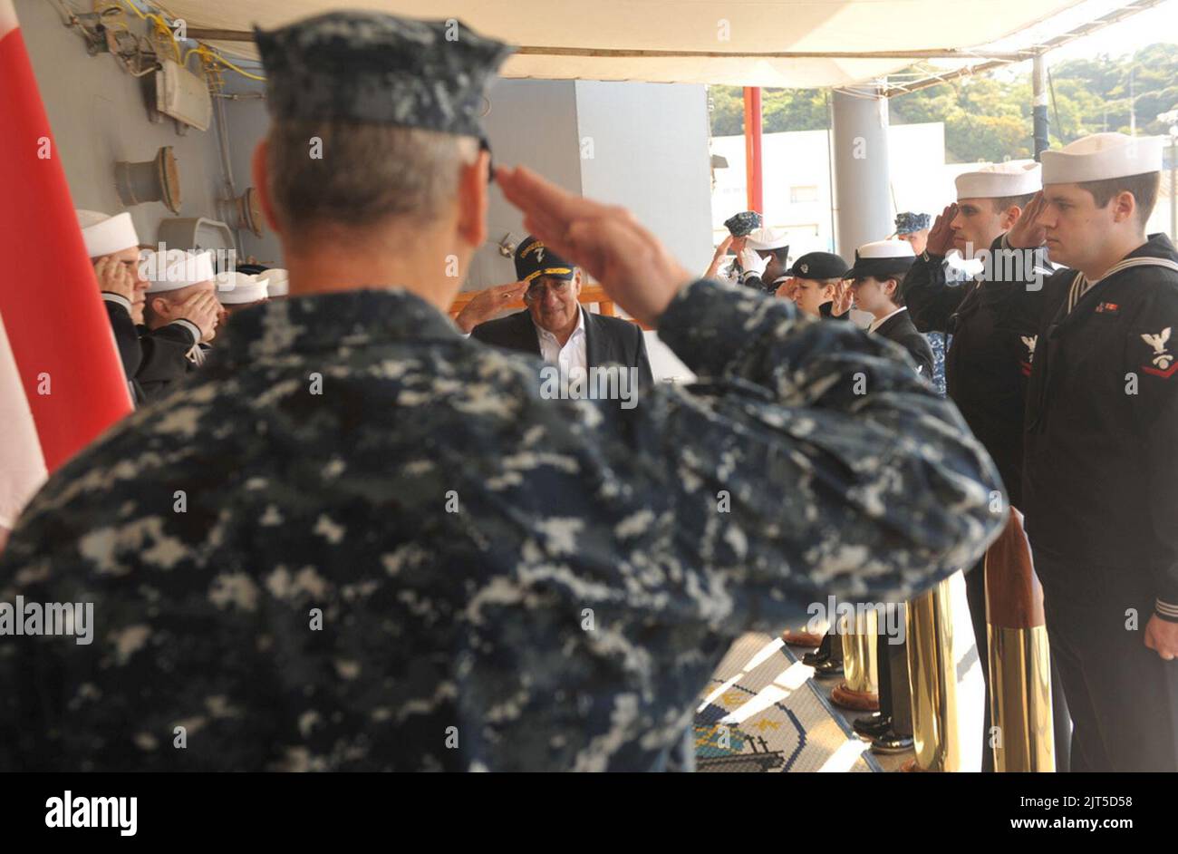 U.S. Secretary of Defense Leon E. Panetta, center, salutes Navy Capt ...