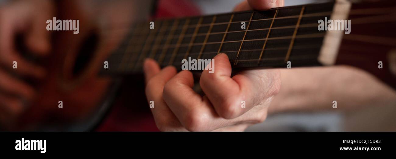 male hands of an elderly senior caucasian man holding and playing a ...