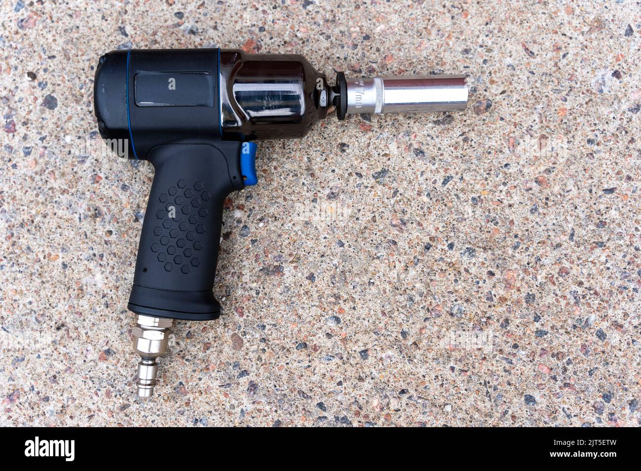 a pneumatic impact wrench with an end head on the concrete floor Stock ...