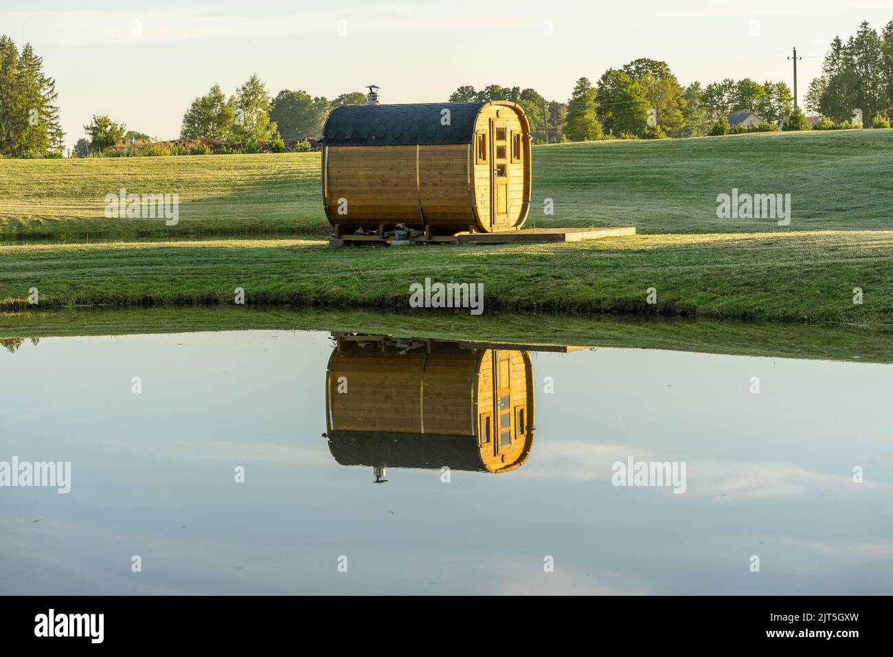 Sauna at the lake shore with reflection in water Stock Photo - Alamy