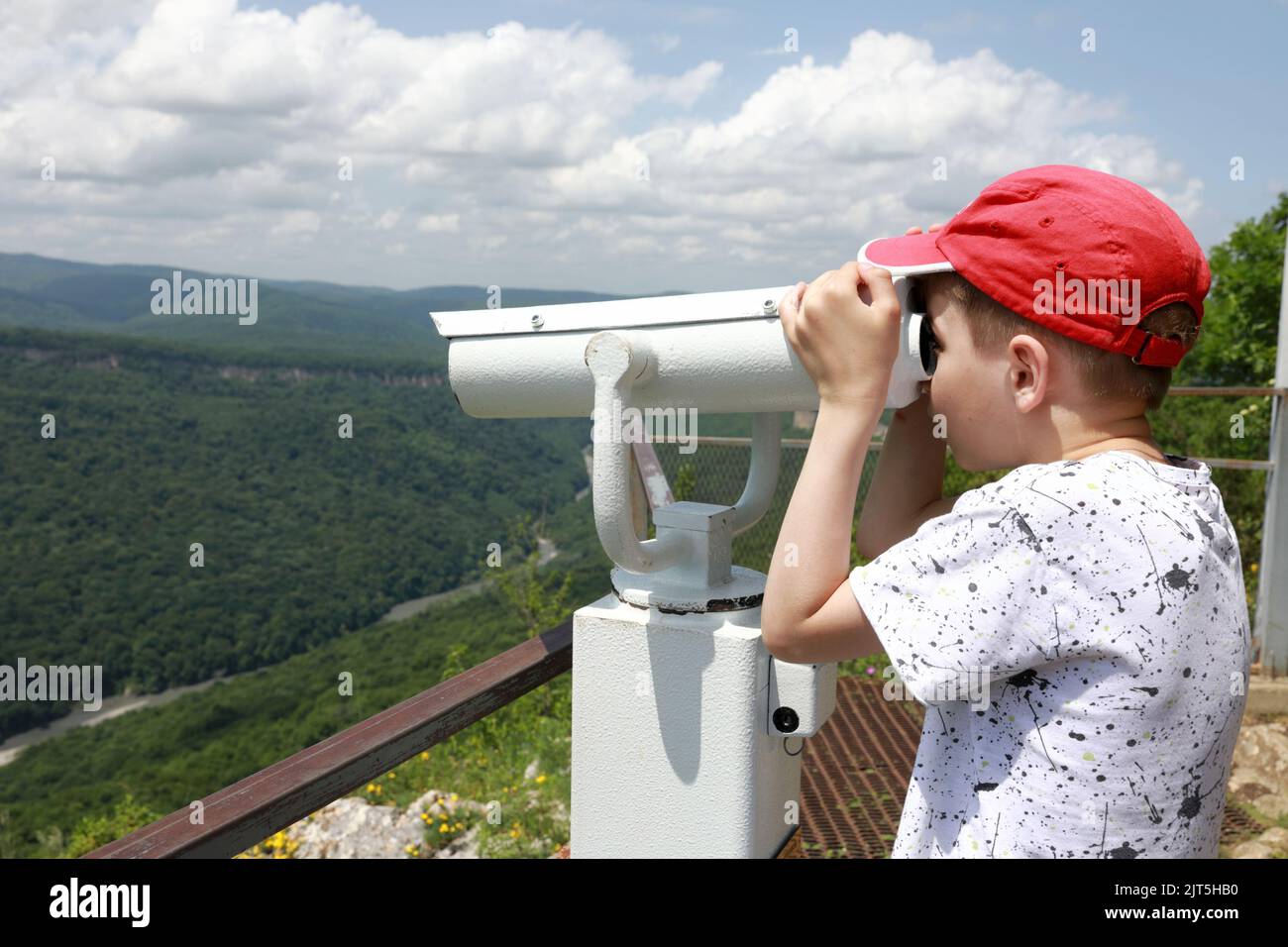 Kid looking through binoculars at valley of Belaya River from Una-koz ridge, Adygea Stock Photo ...