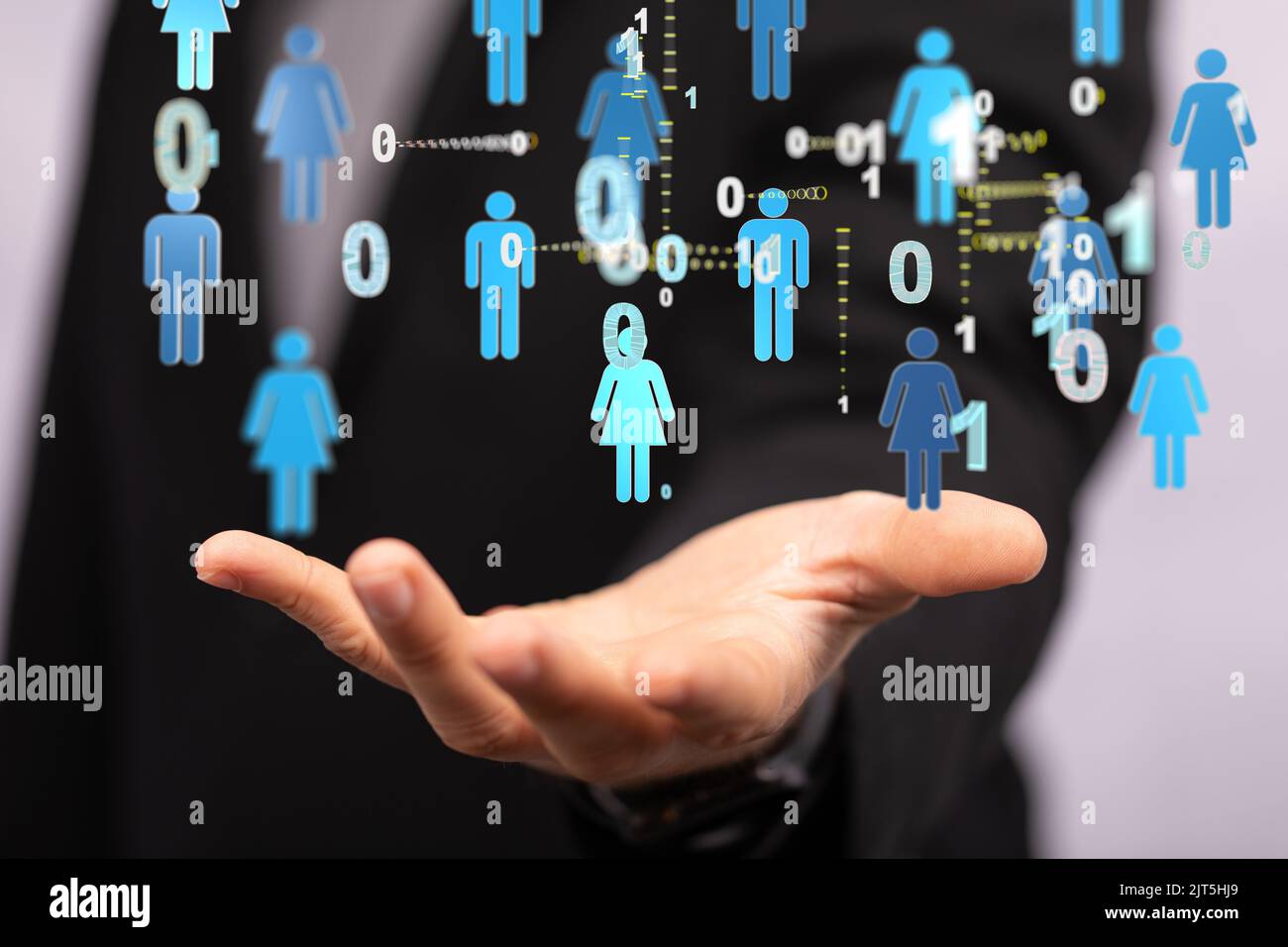 The palm of the hand holding a network with blue male and female icons ...