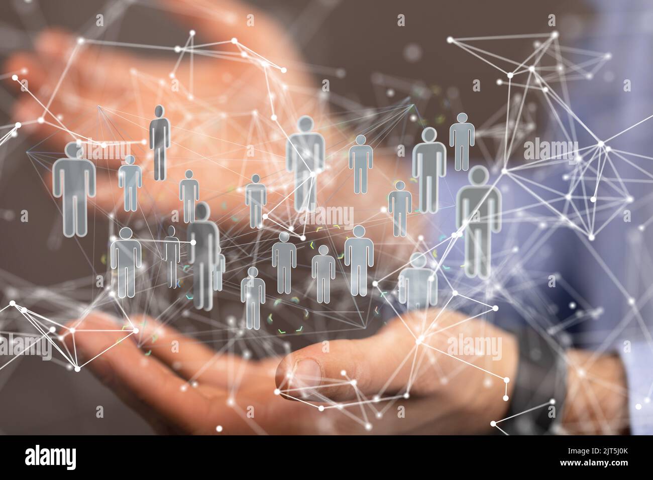 The palm of the hand holding a network with gray male and female icons ...