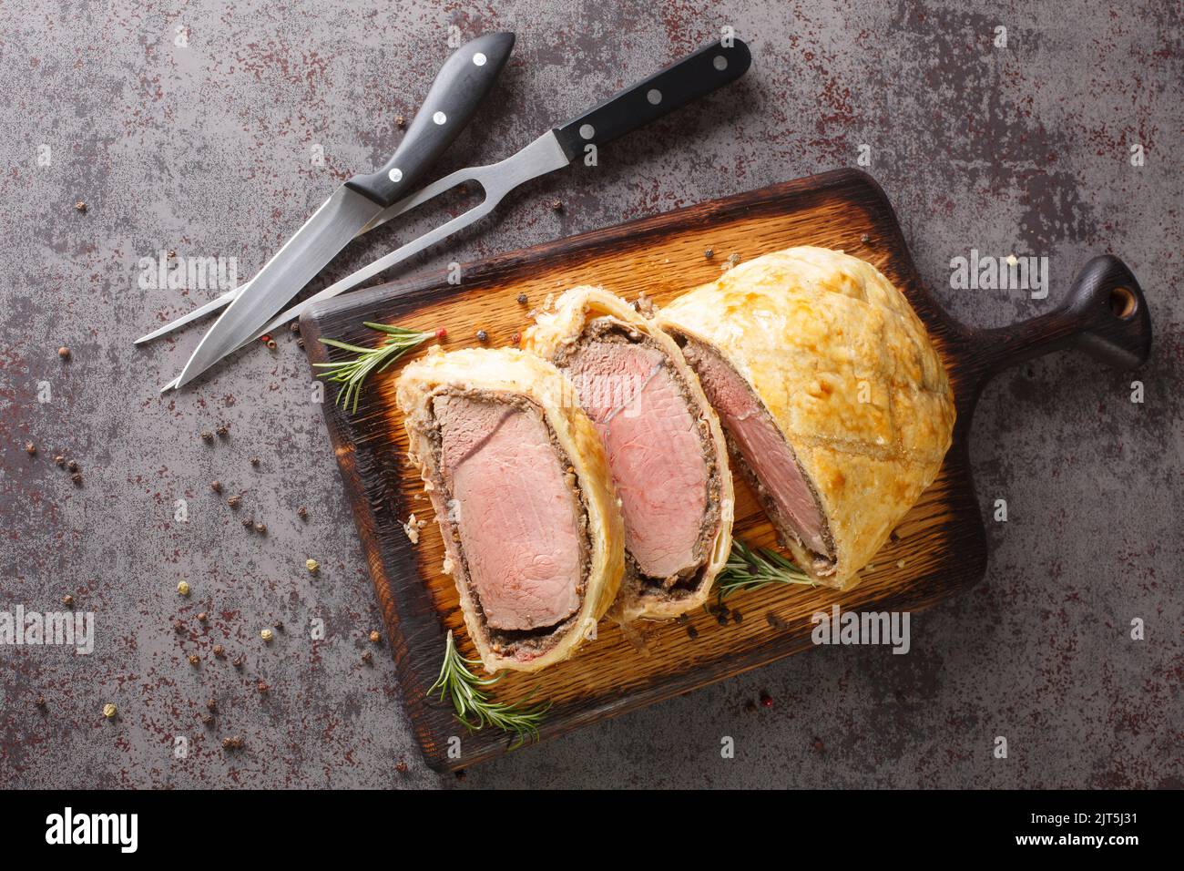 Medium Beef Wellington classic sliced steak closeup on rustic wooden ...
