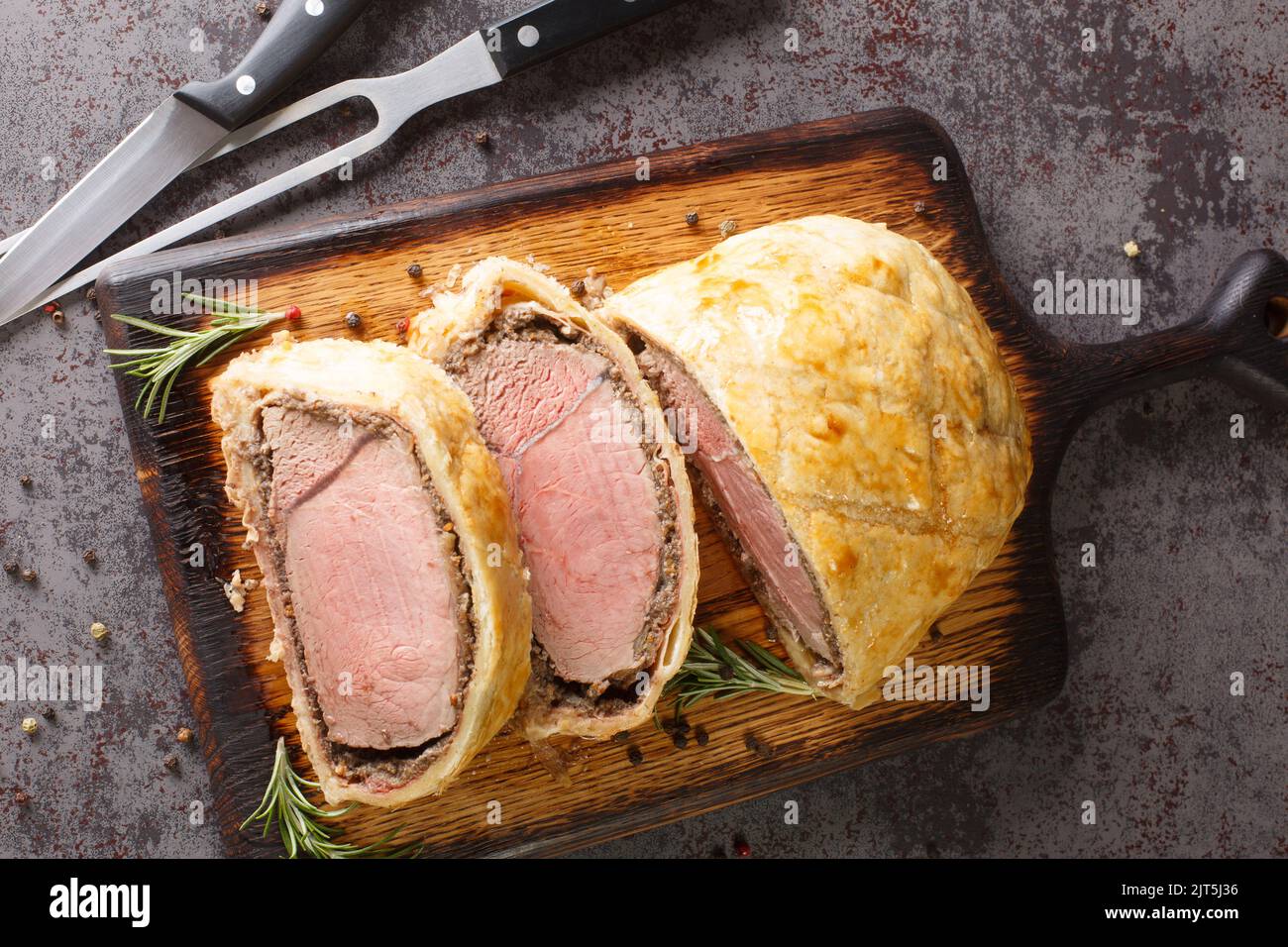 Beef Wellington classic steak dish closeup on rustic wooden board ...