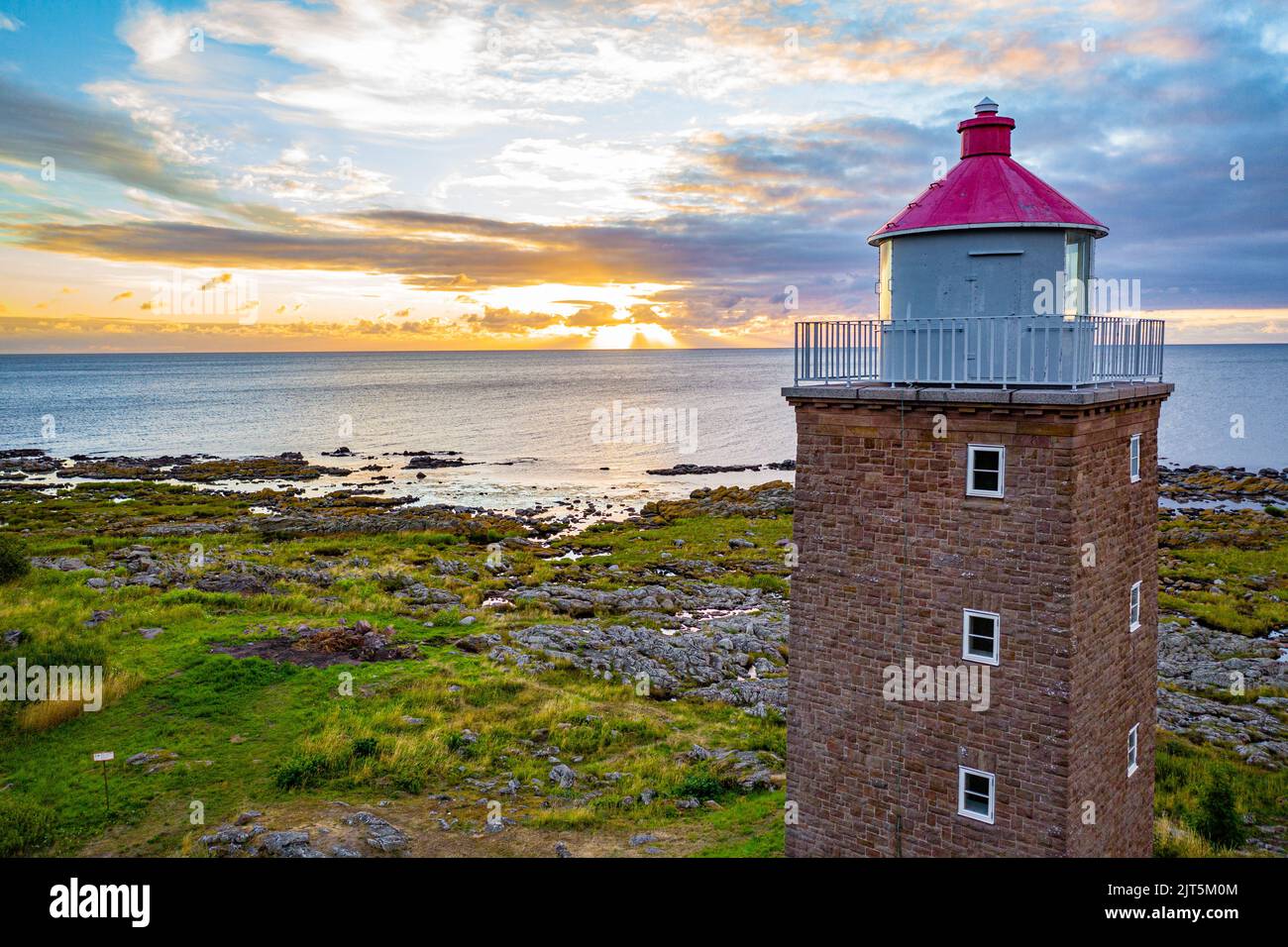 closeup aerial view of lighthouse on the coast of the sea on bornholm ...