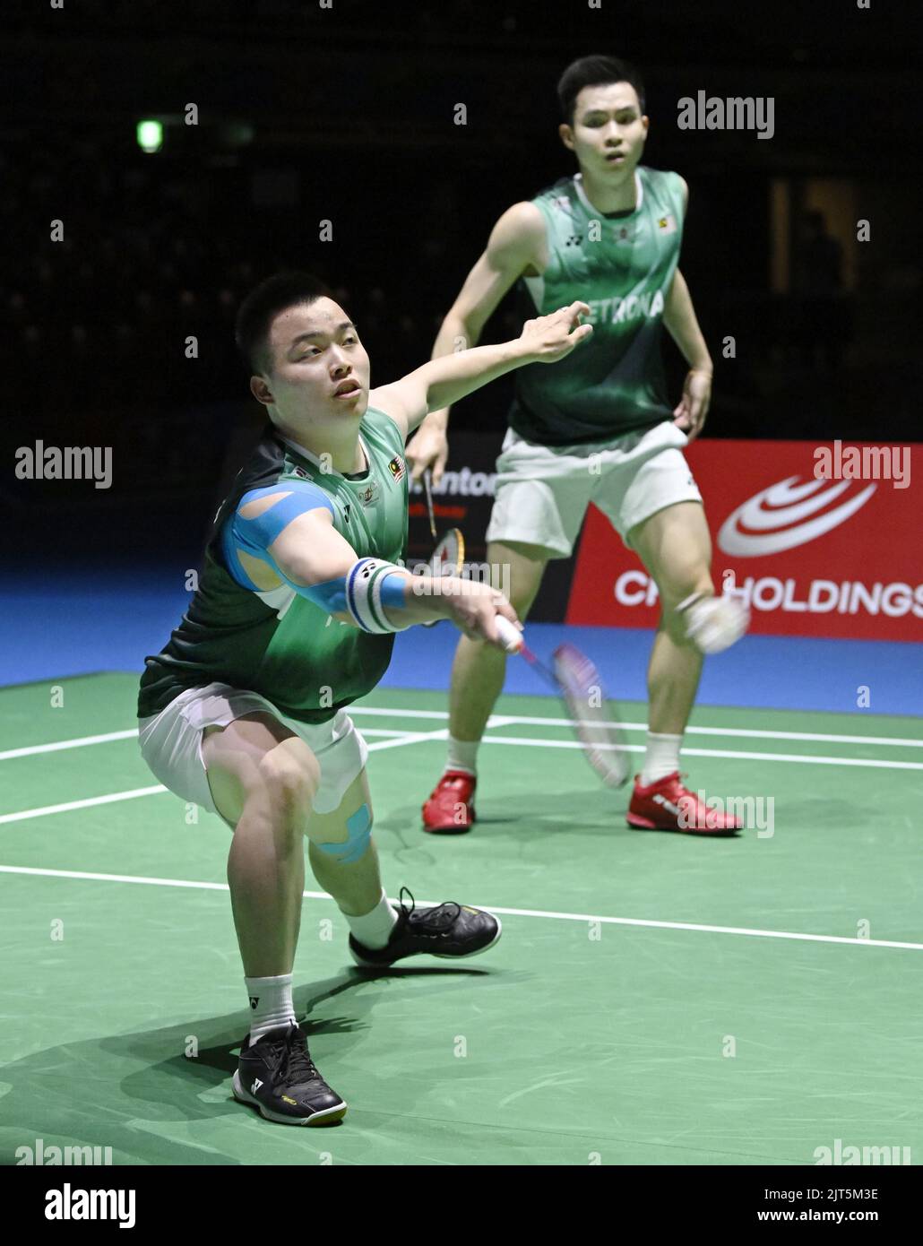 Malaysia's Aaron Chia (front) and Soh Wooi Yik play en route beating Indonesia's Mohammad Ahsan ...