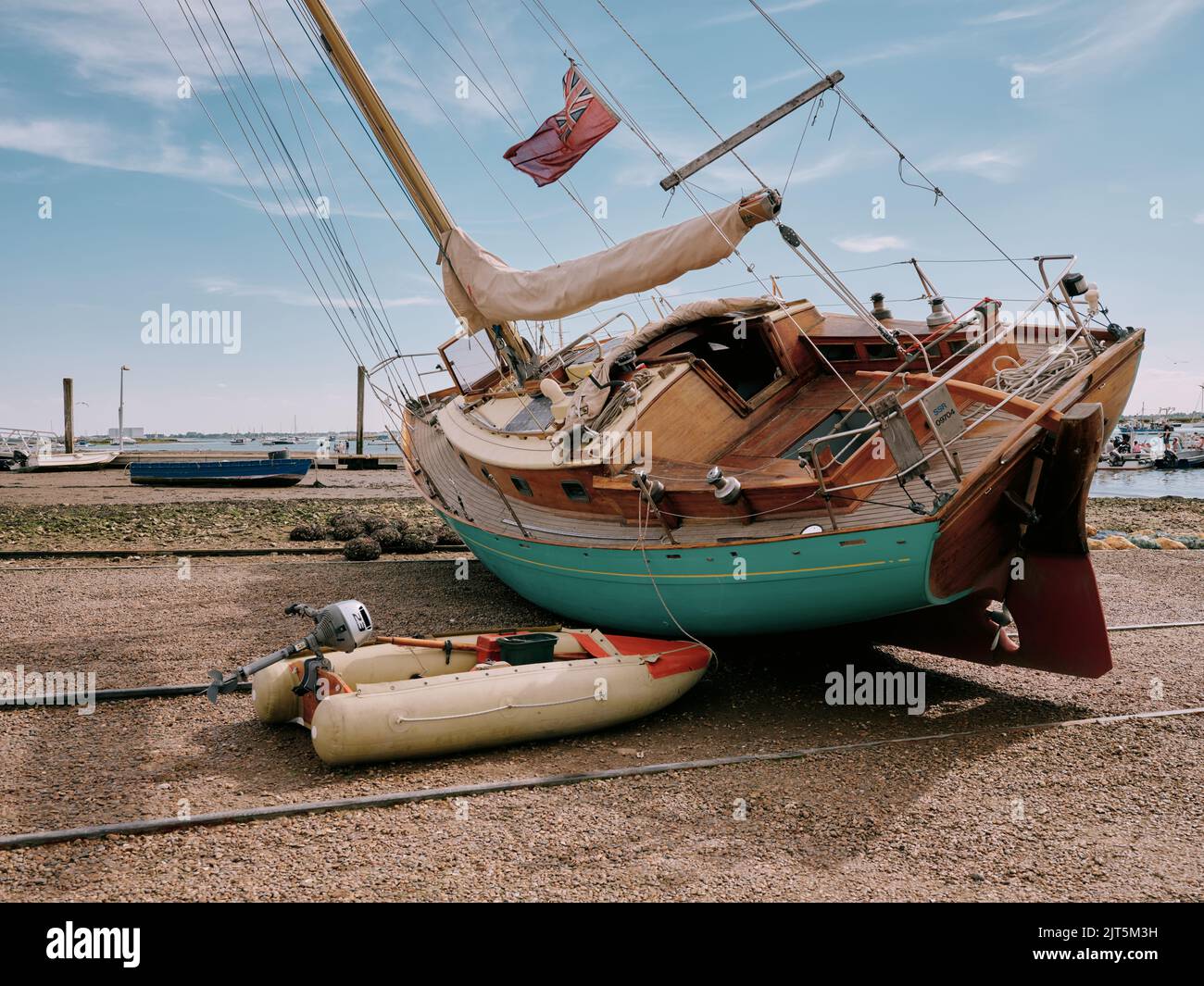A yacht on the hard in the low tide summer landscape and boats at West ...