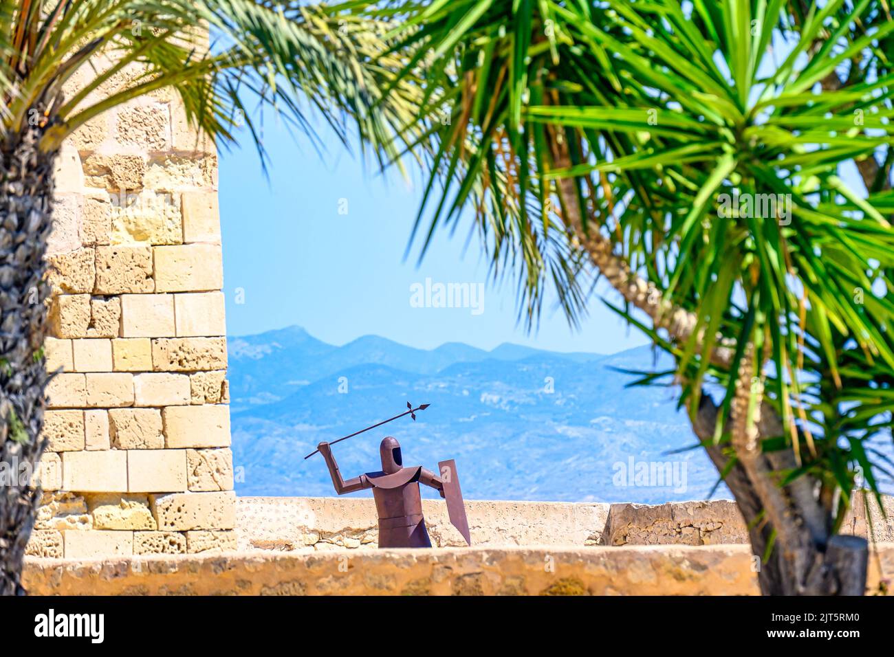 Metallic sculpture of a soldier with a shield and a spear. The stone ...