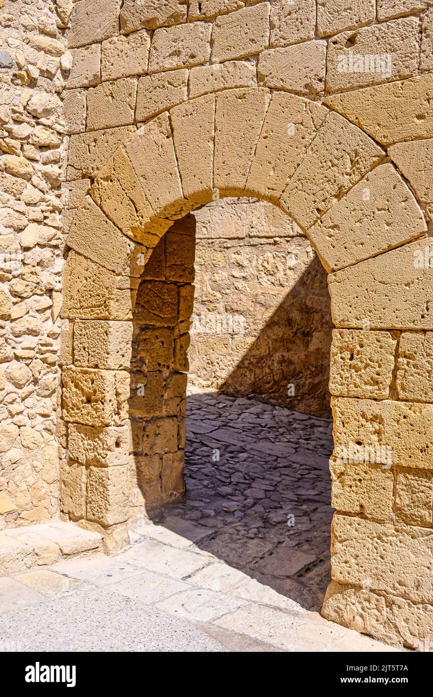 Stone arched door inside the walls of the medieval military fort which ...