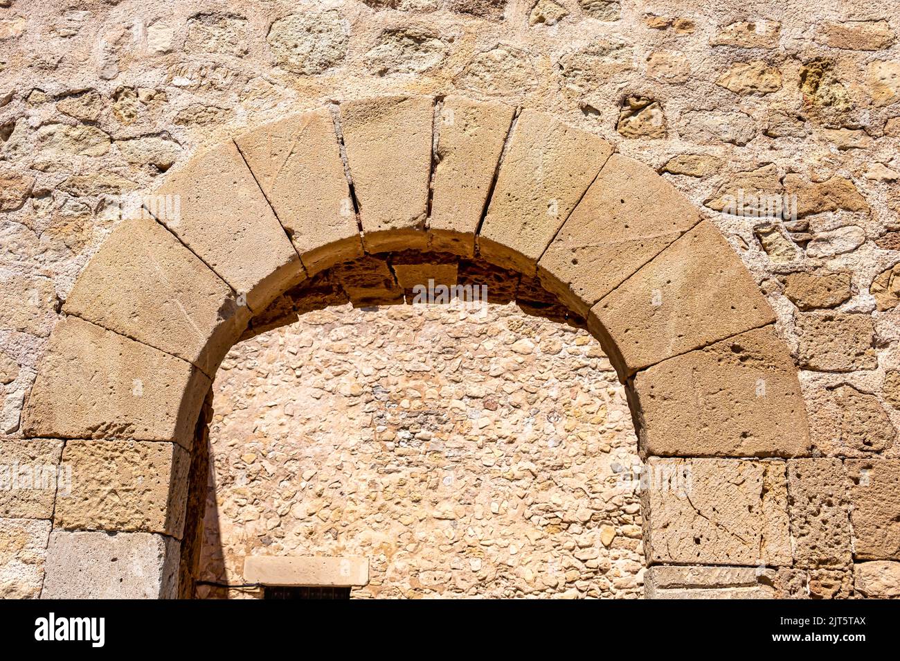 Stone arched door inside the walls of the medieval military fort which ...