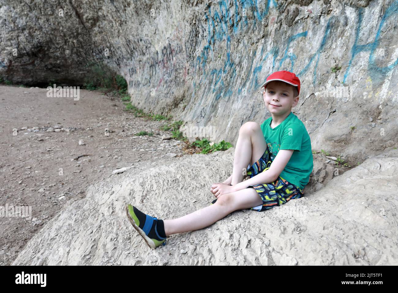 Boy sitting on stone wall hi-res stock photography and images - Alamy
