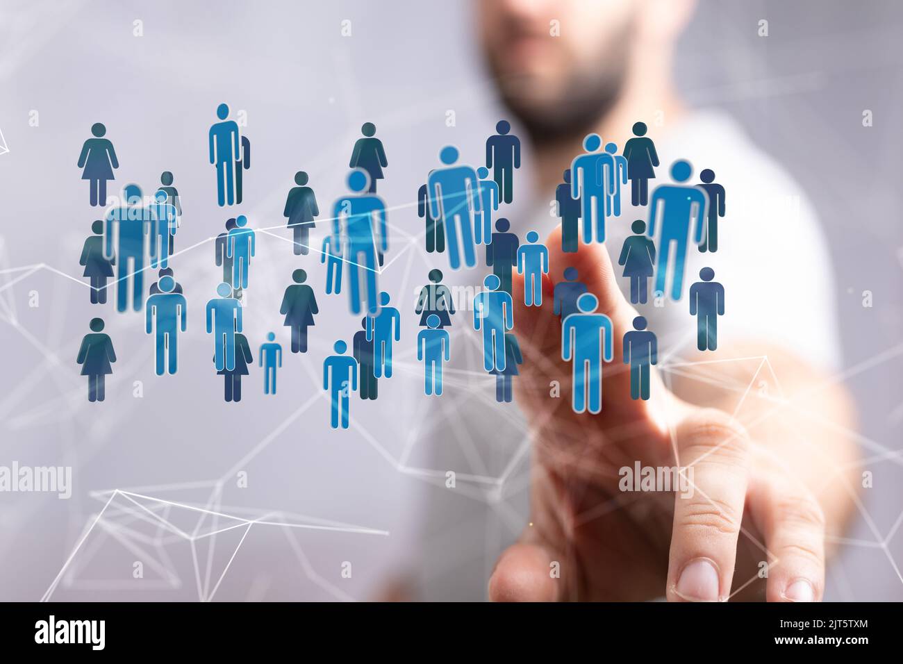 The man's hand touching hovering human icons Stock Photo - Alamy