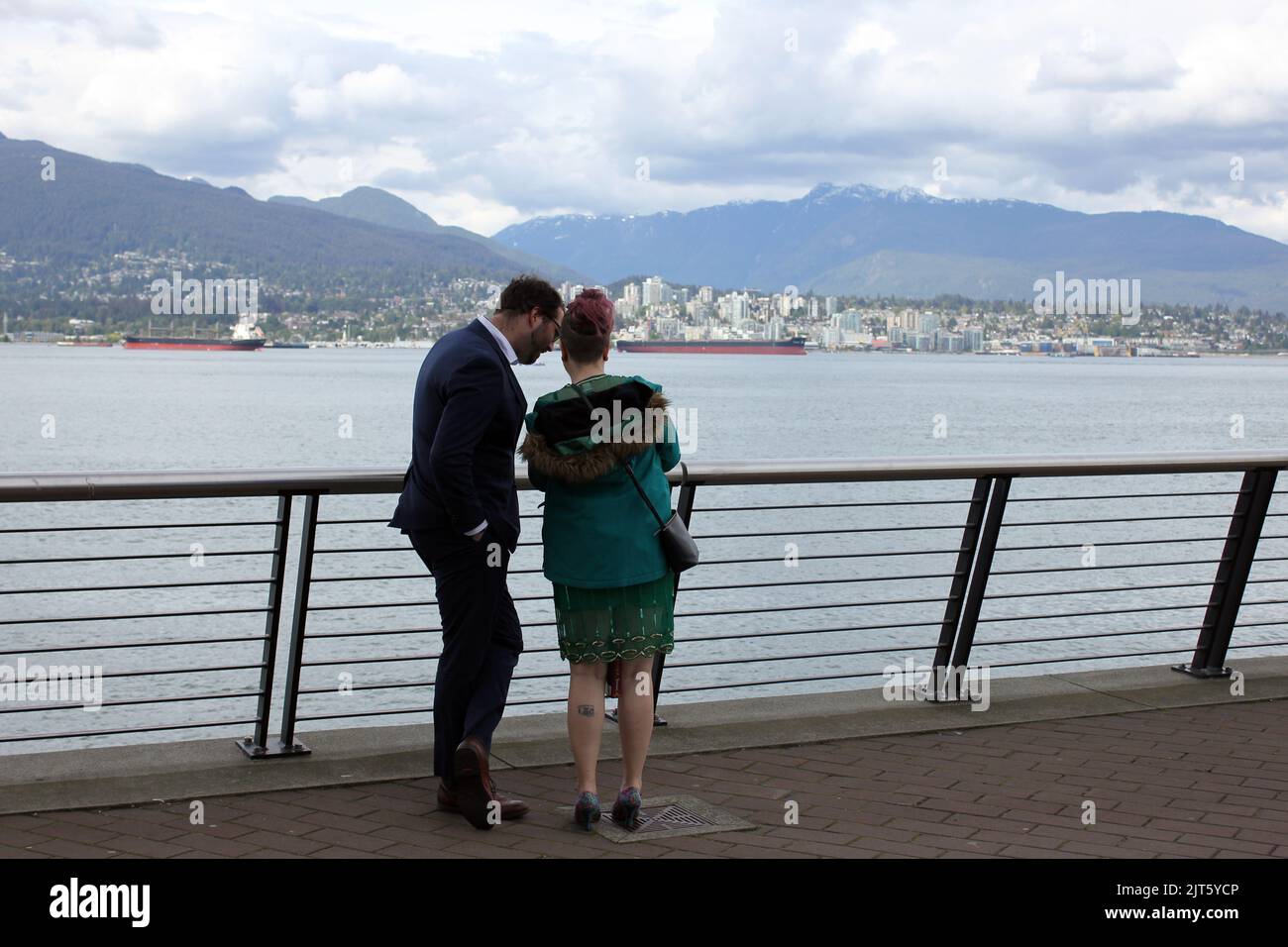 A Young couple watching photos on the phone at the waterfront in ...