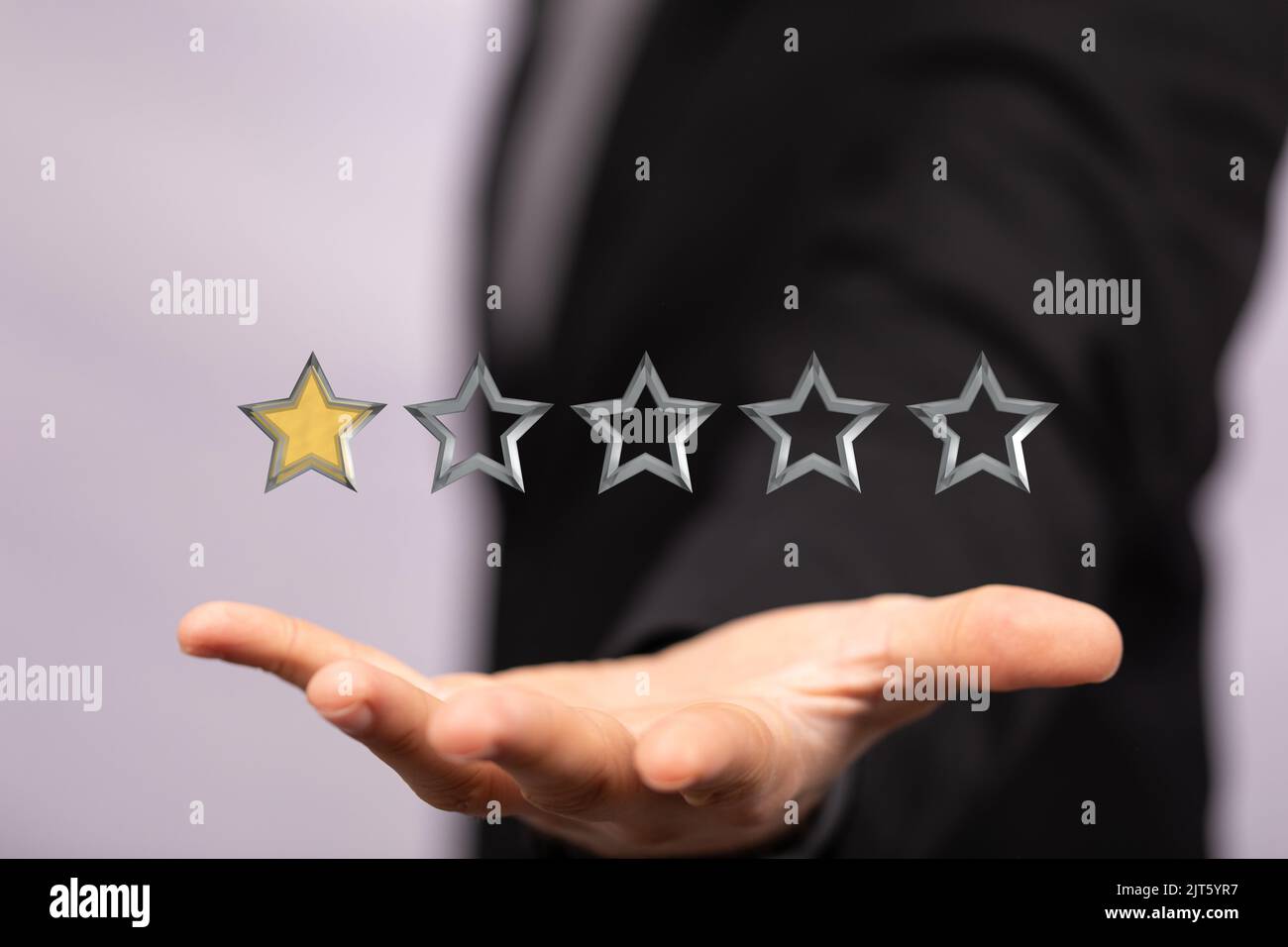 A 3D rendered five-star icon hovering in mans hand Stock Photo - Alamy