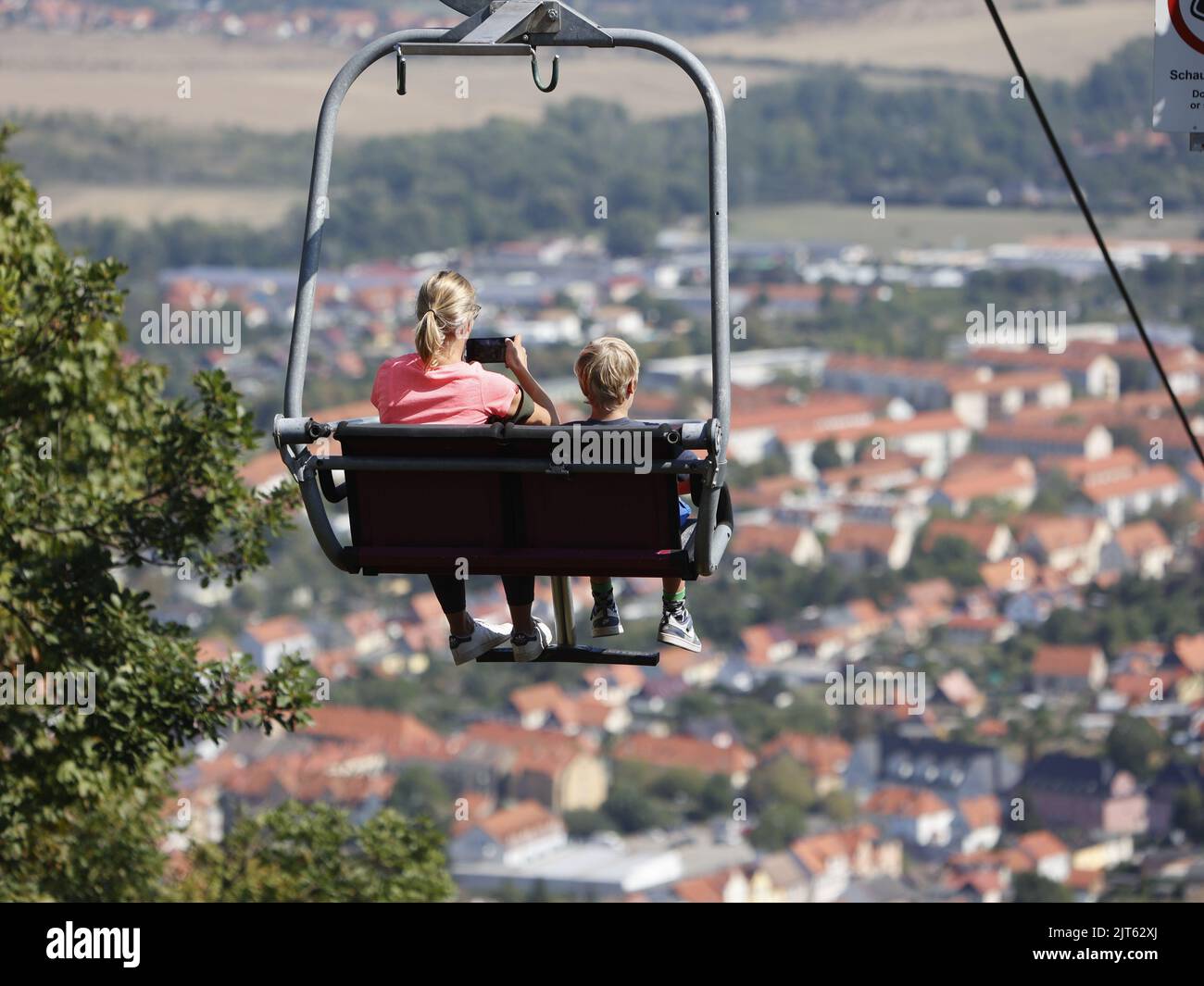 Thale, Germany. 28th Aug, 2022. Visitors take the chairlift to the ...