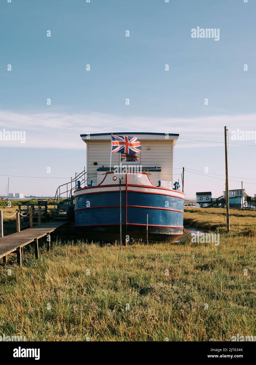 The summer houseboat and low tide salt marsh landscape of West Mersea ...