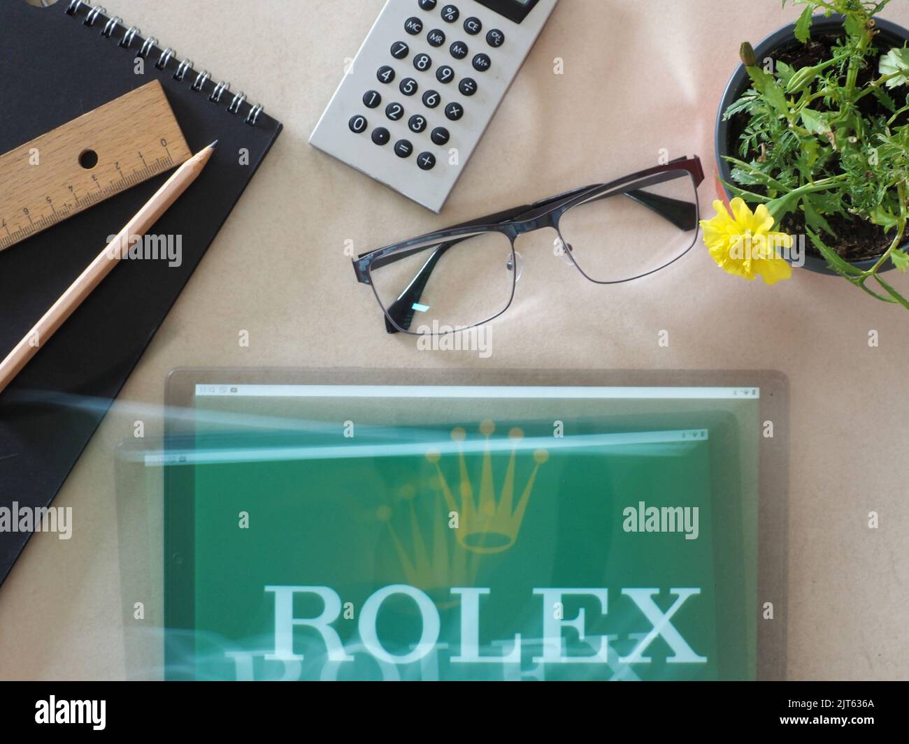 In this photo illustration, a Rolex SA logo seen displayed on a tablet ...