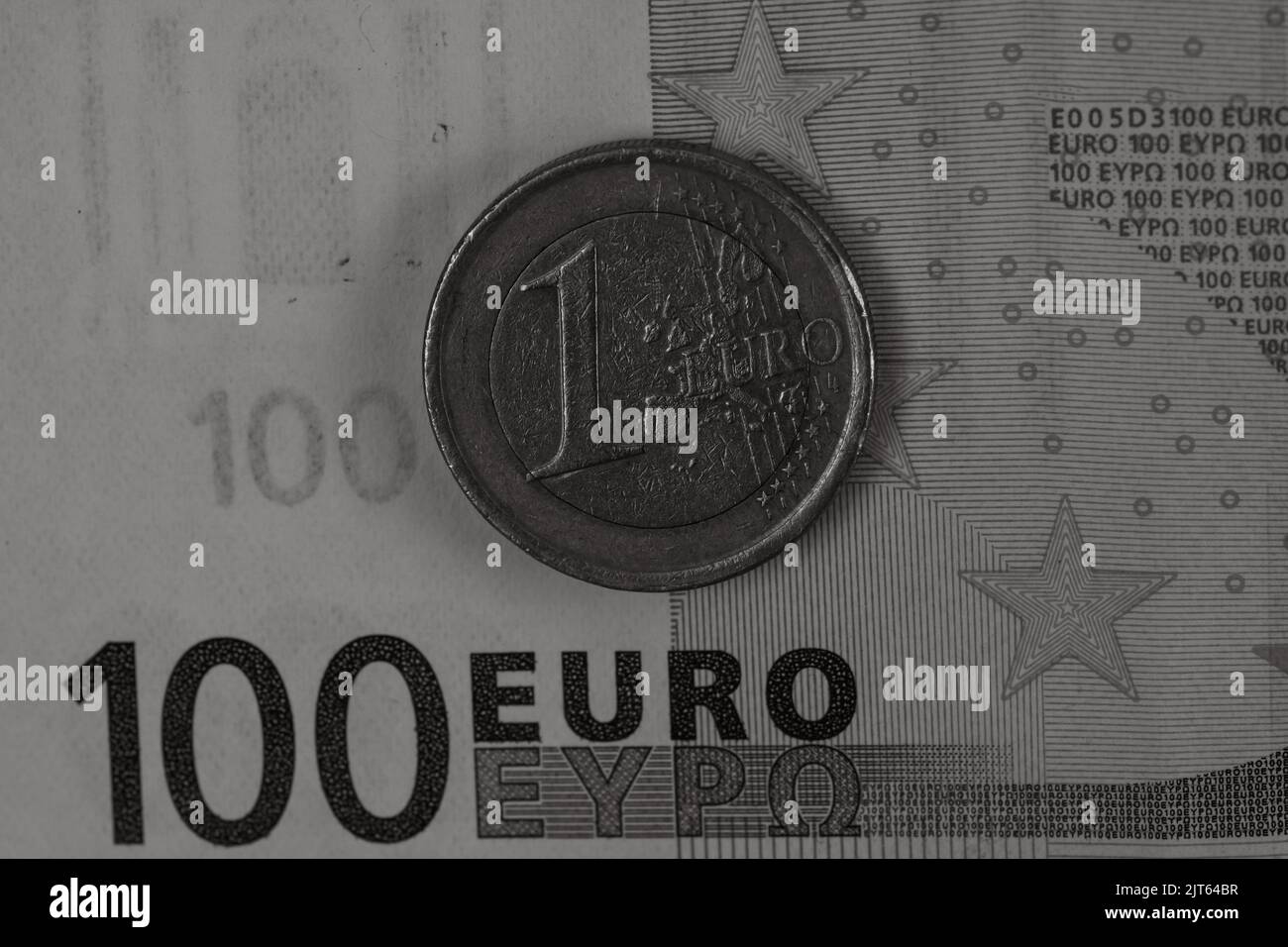 A grayscale closeup shot of details on a hundred Euro banknote and a ...