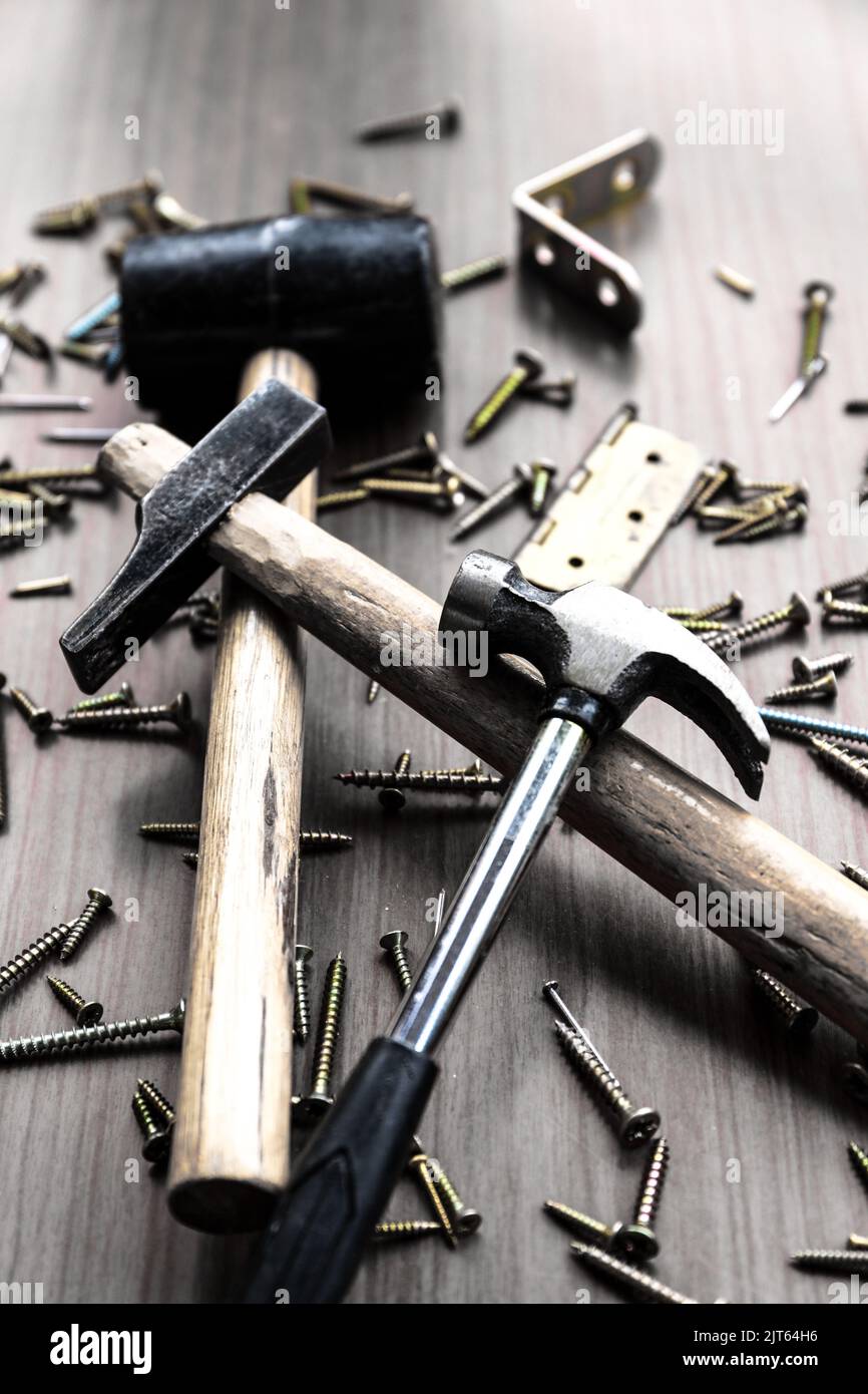 A vertical shot of a rubber mallet with a sledgehammer, claw hammer and ...