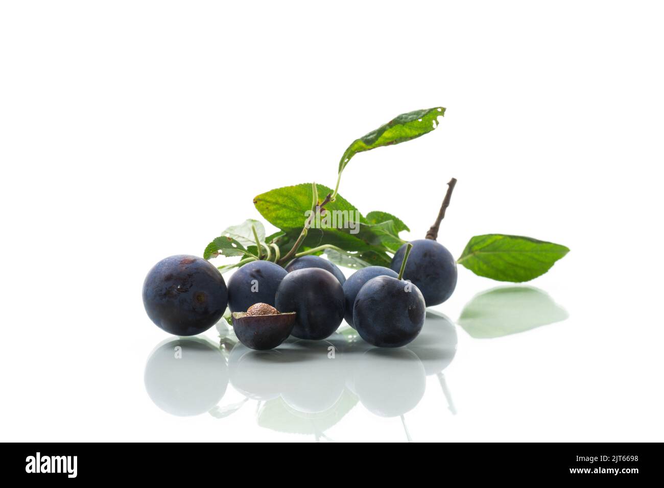 Ripe whole round plums with leaves isolated on white background Stock ...