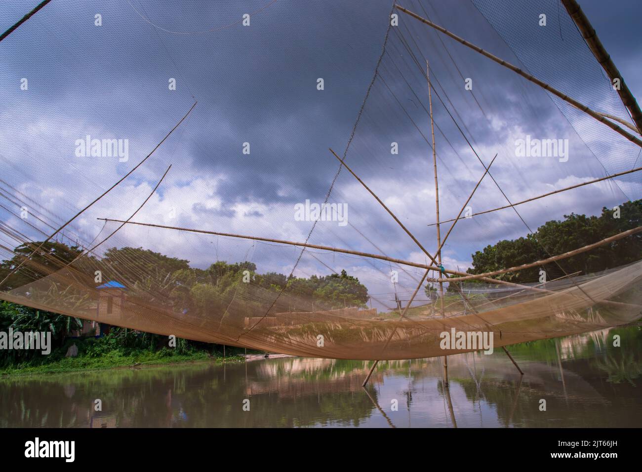Traditional Fishing net Vessel in the river water by Bangladesh Stock ...