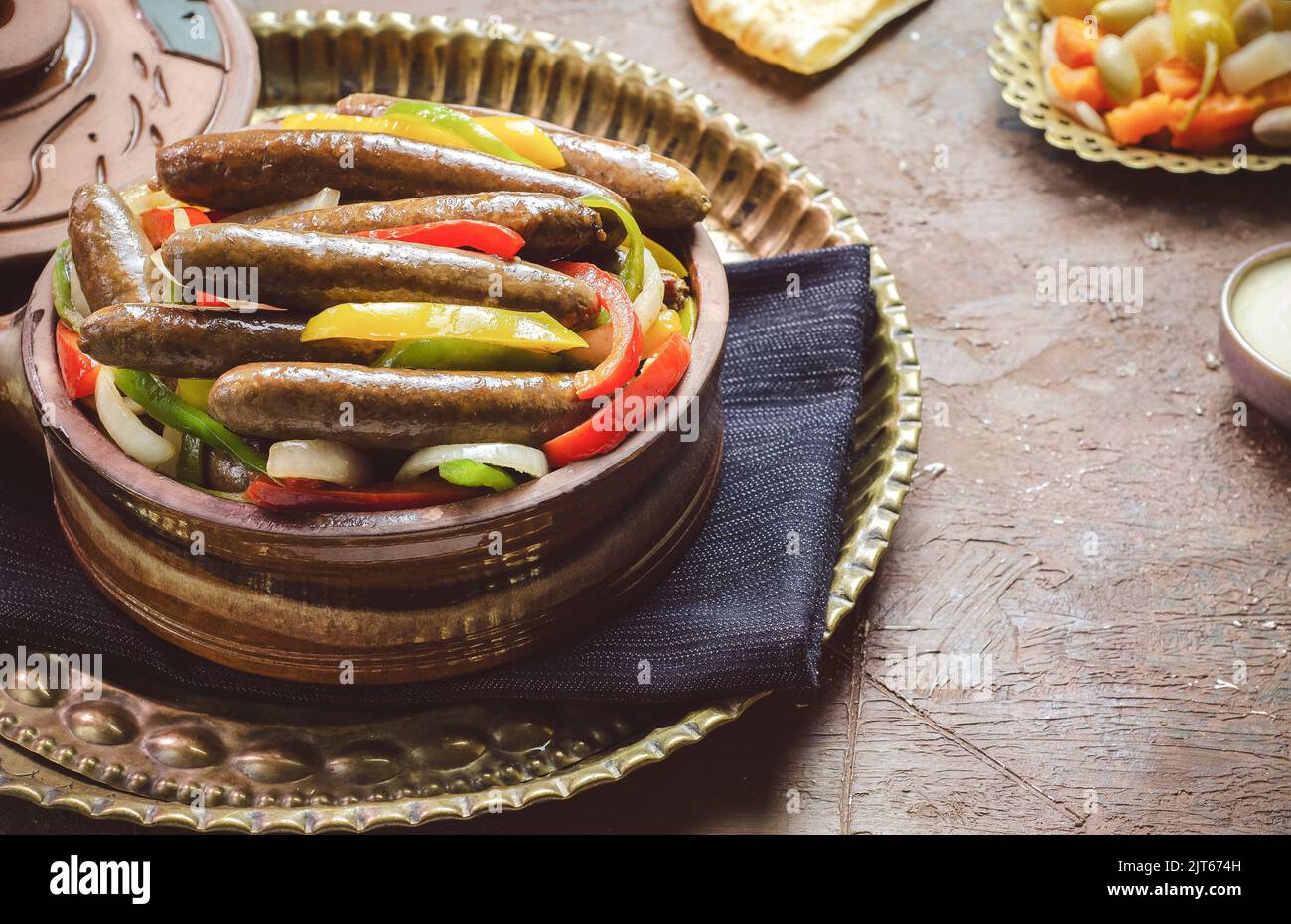 Arabic cuisine; Egyptian traditional sausage with onions, bell peppers ...