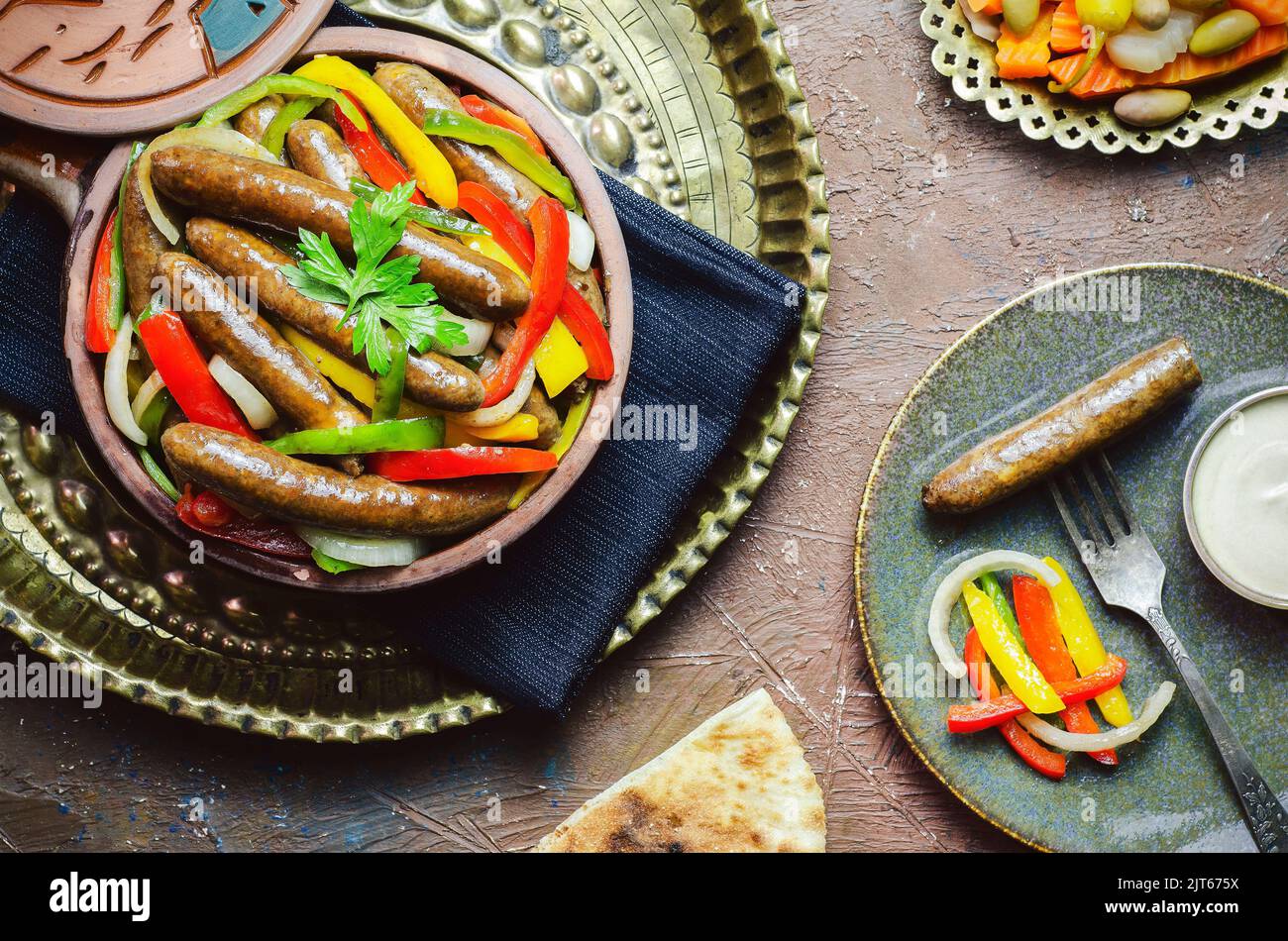 Arabic cuisine; Egyptian traditional sausage with onions, bell peppers ...