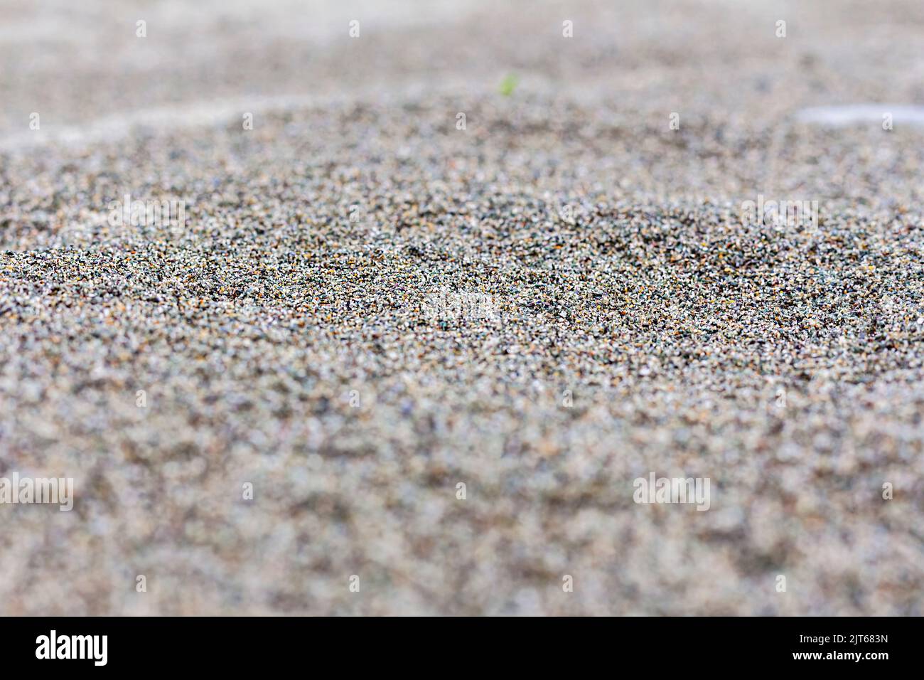 Close-up of texture beige or multi-colored fine sand with copy space ...