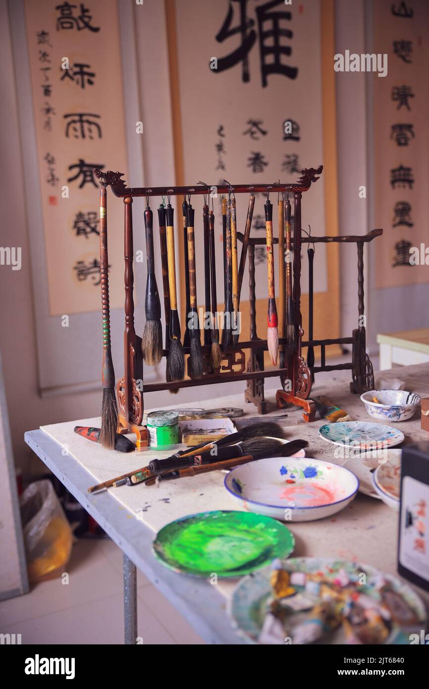 Paint brushes of a traditional chinese painter artist hanging on the ...