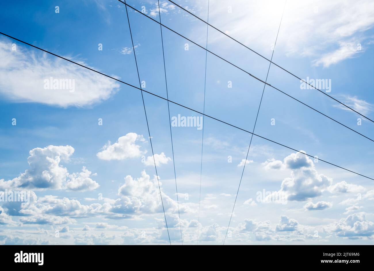 Blue sky and clouds with electric cables Stock Photo - Alamy