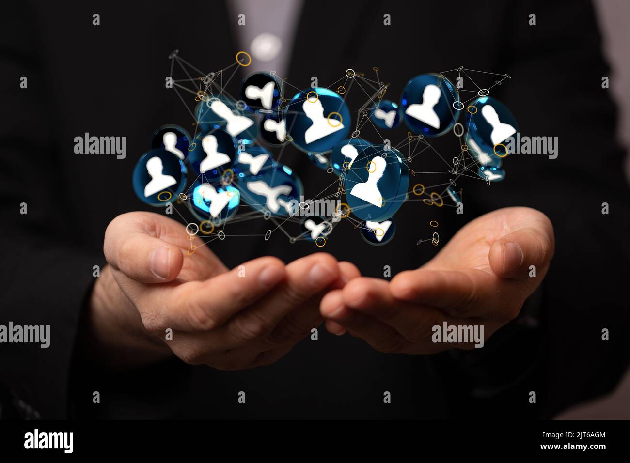 A closeup of hands holding 3D rendered human icons, internet and ...