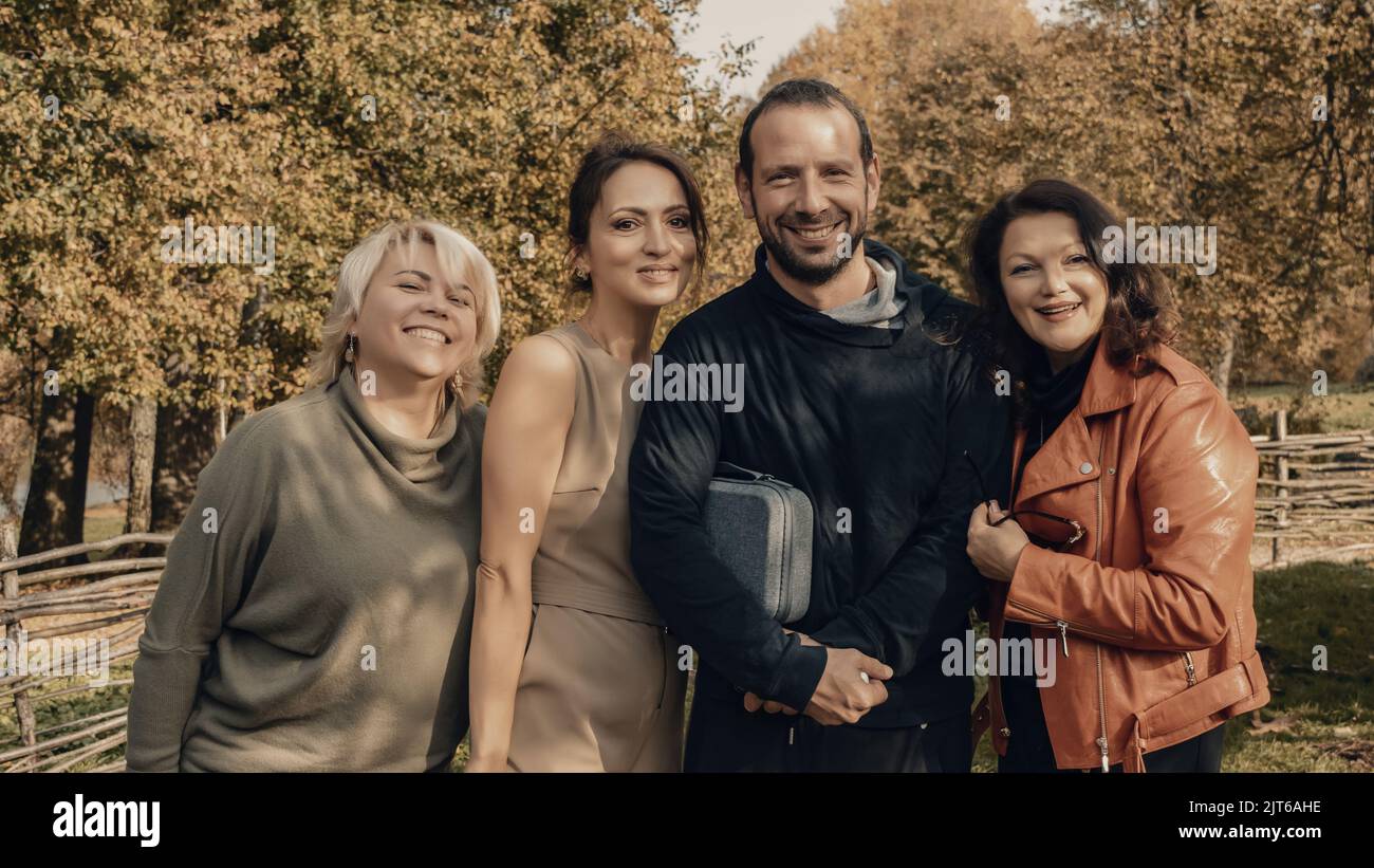 Group of happy people spending their weekend in nature. Portrait of ...