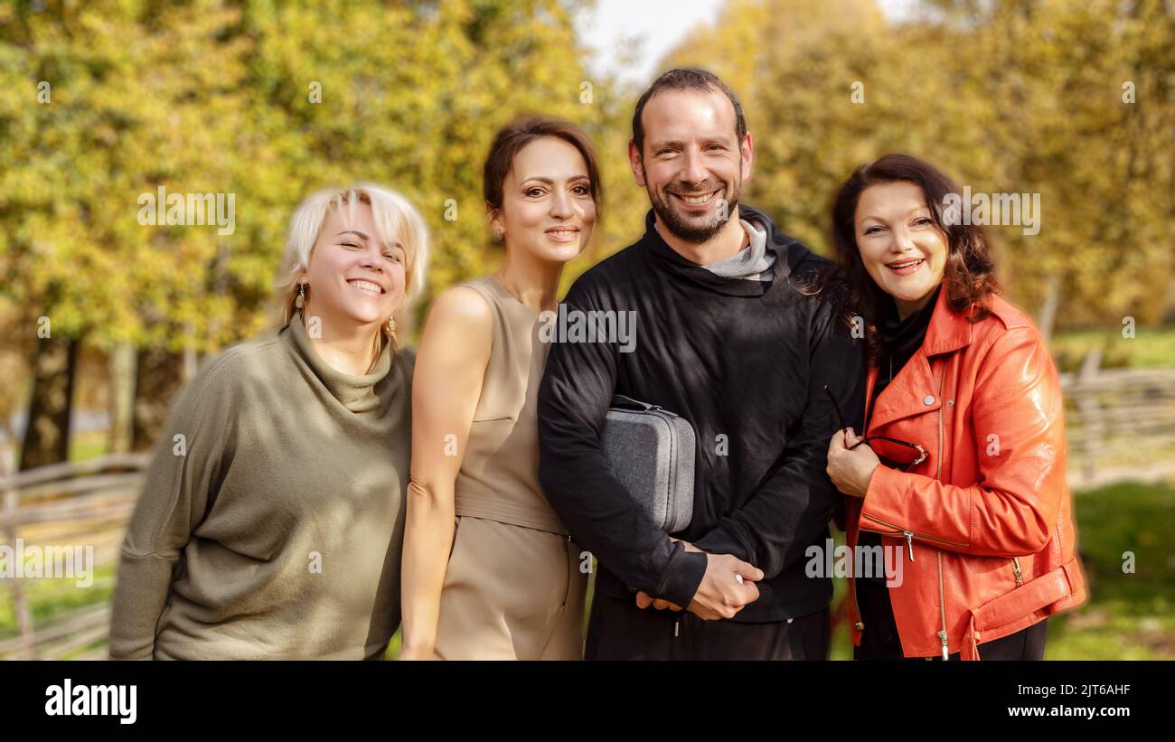 Group of happy people spending their weekend in nature. Portrait of ...