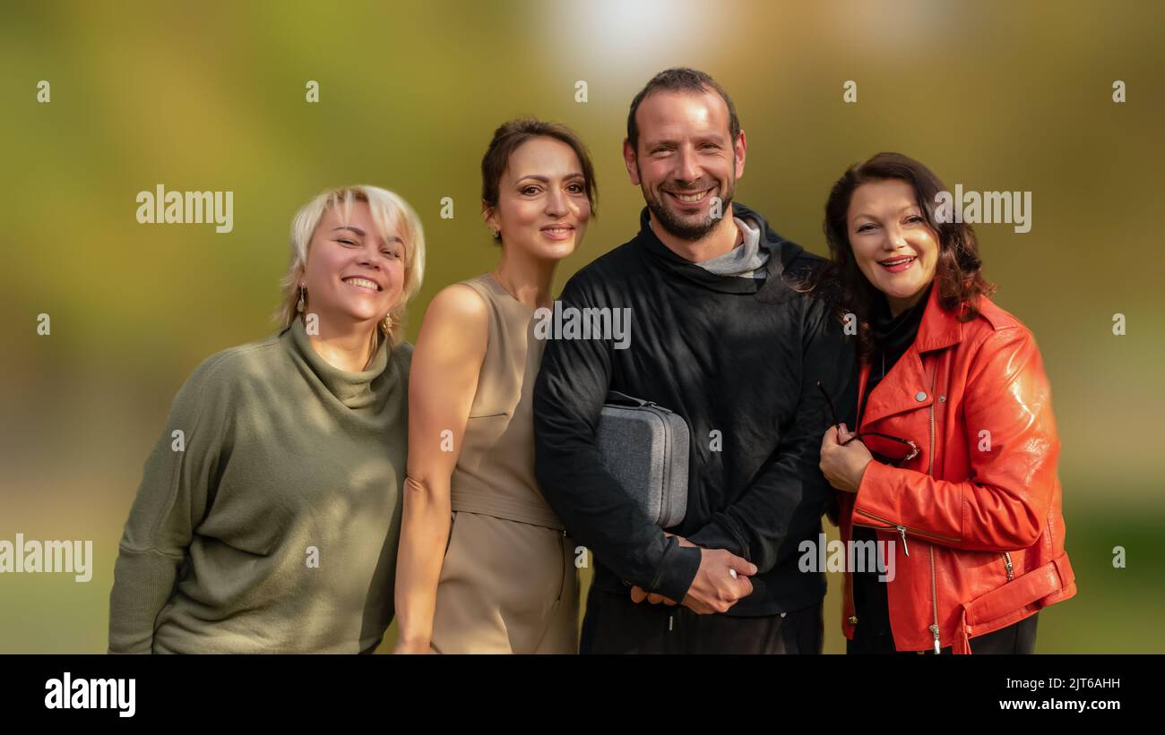 Group of happy people spending their weekend in nature. Portrait of ...