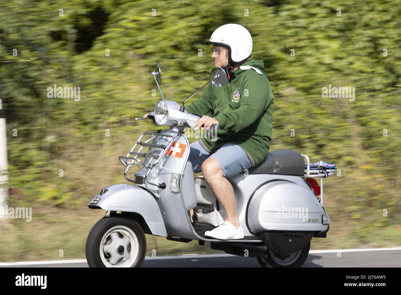 Man drive a Vespa Stock Photo - Alamy
