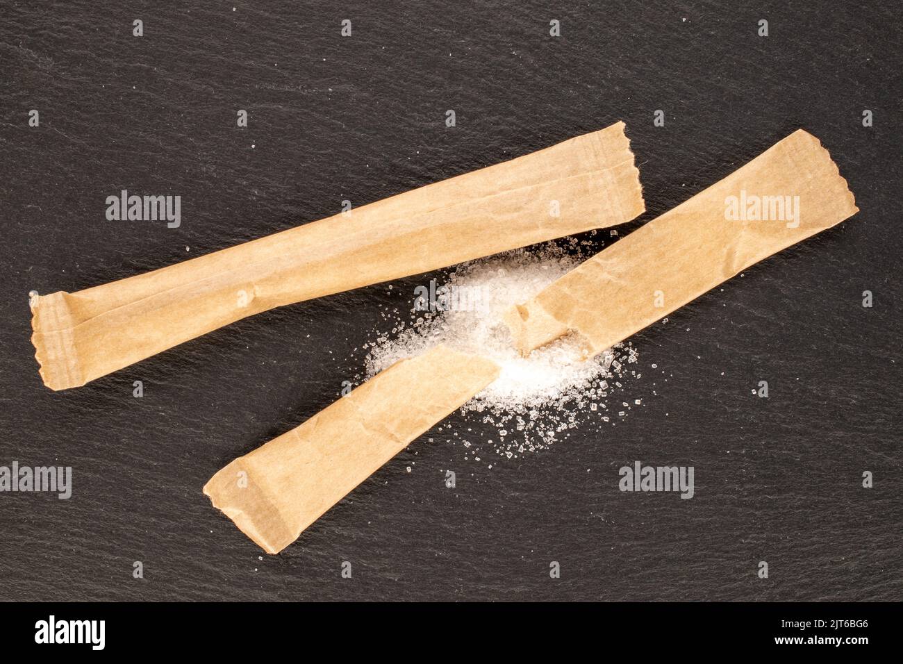 Two paper sticks with sugar on slate stone, close-up, top view Stock ...